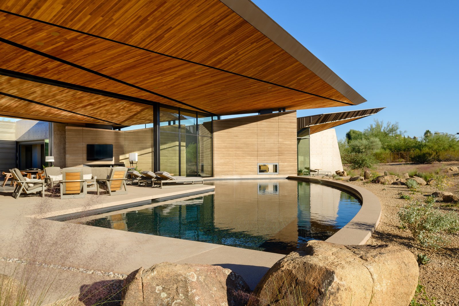 Photo 4 of 14 in A Dramatic Floating Roof Crowns This Rammed Earth Home ...