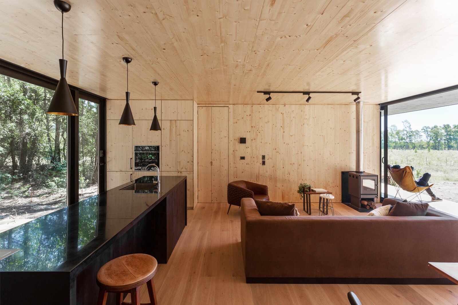 Photo 3 of 9 in This Black Prefab Cabin in Uruguay “Melts” Into the ...