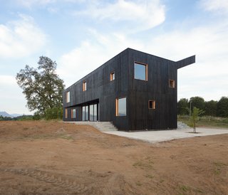 A Black Timber Home in Chile Echoes Local Volcanic Stone - Dwell