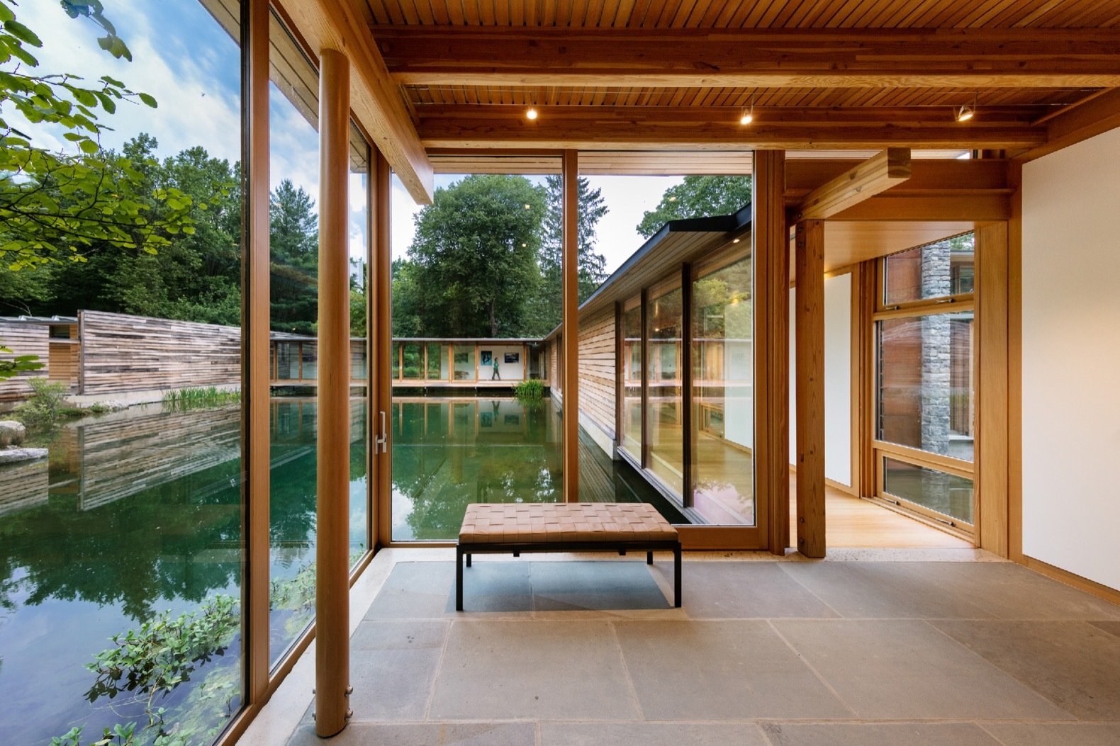 Photo 2 of 17 in This Striking Net-Zero Home Wraps Around a Serene Pond ...