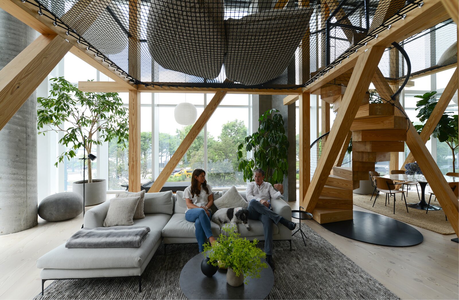 Photo 1 of 12 in A Wood Canopy With Netting Fills Out a Glass-Wrapped ...