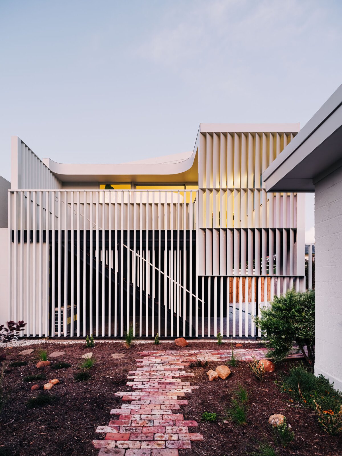 Photo 1 of 12 in A Crisp White One-Bed Addition Is Parked Atop a Two ...